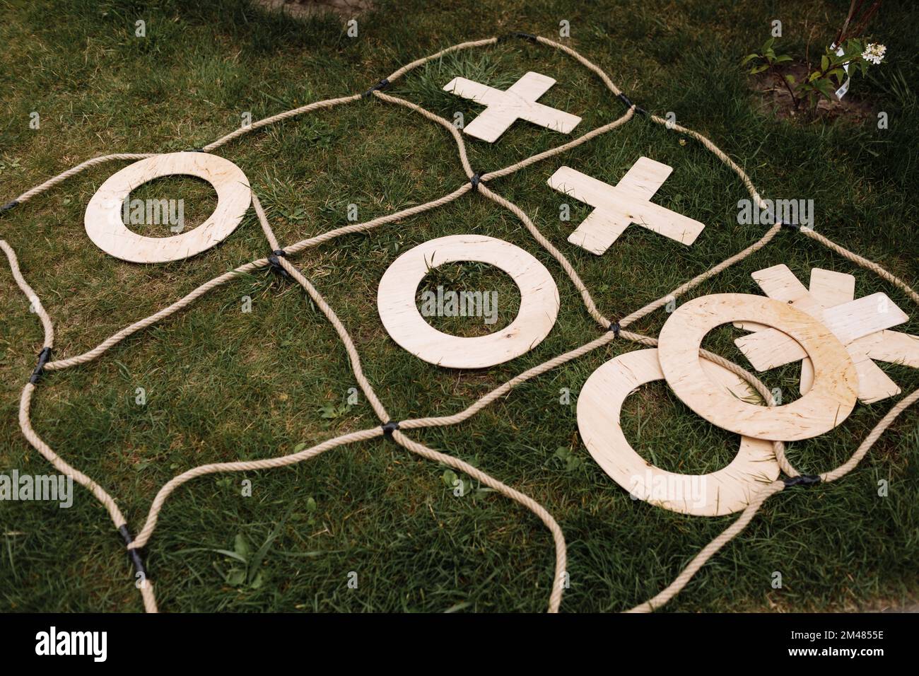 Big wooden Tic Tac Toe game outdoors on green grass background ...