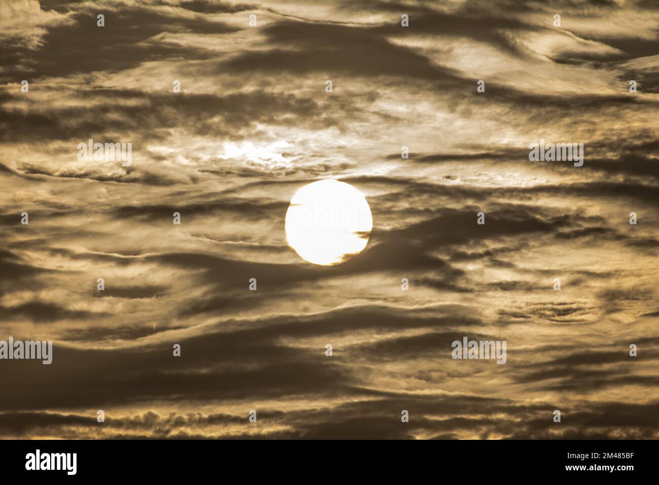 Sun between clouds at beautiful sunset, artistic photo Stock Photo - Alamy