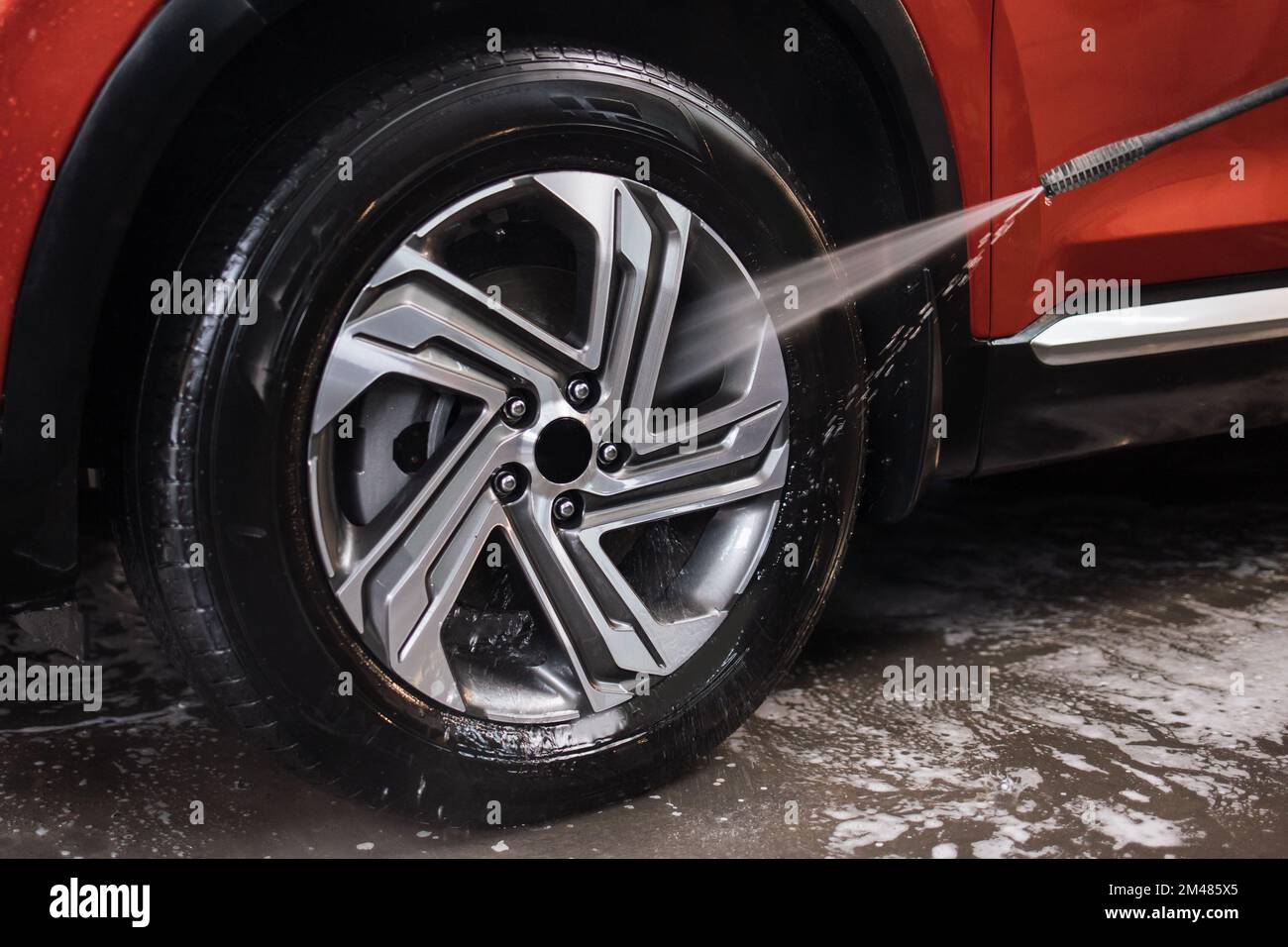 Washing red luxury car in detailing service. Close up image of the ...