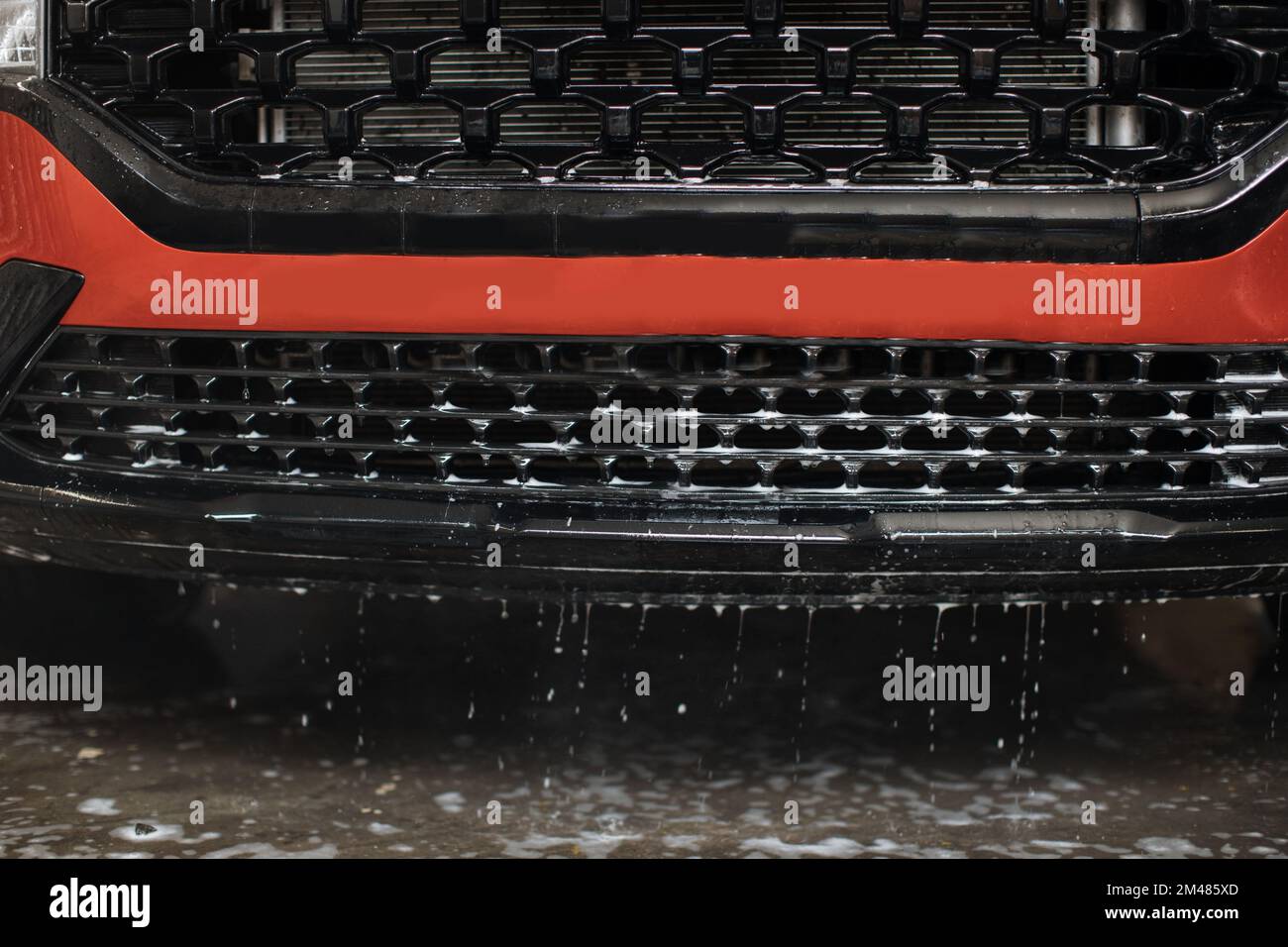 Washing red luxury car in detailing service. Close up image of the ...