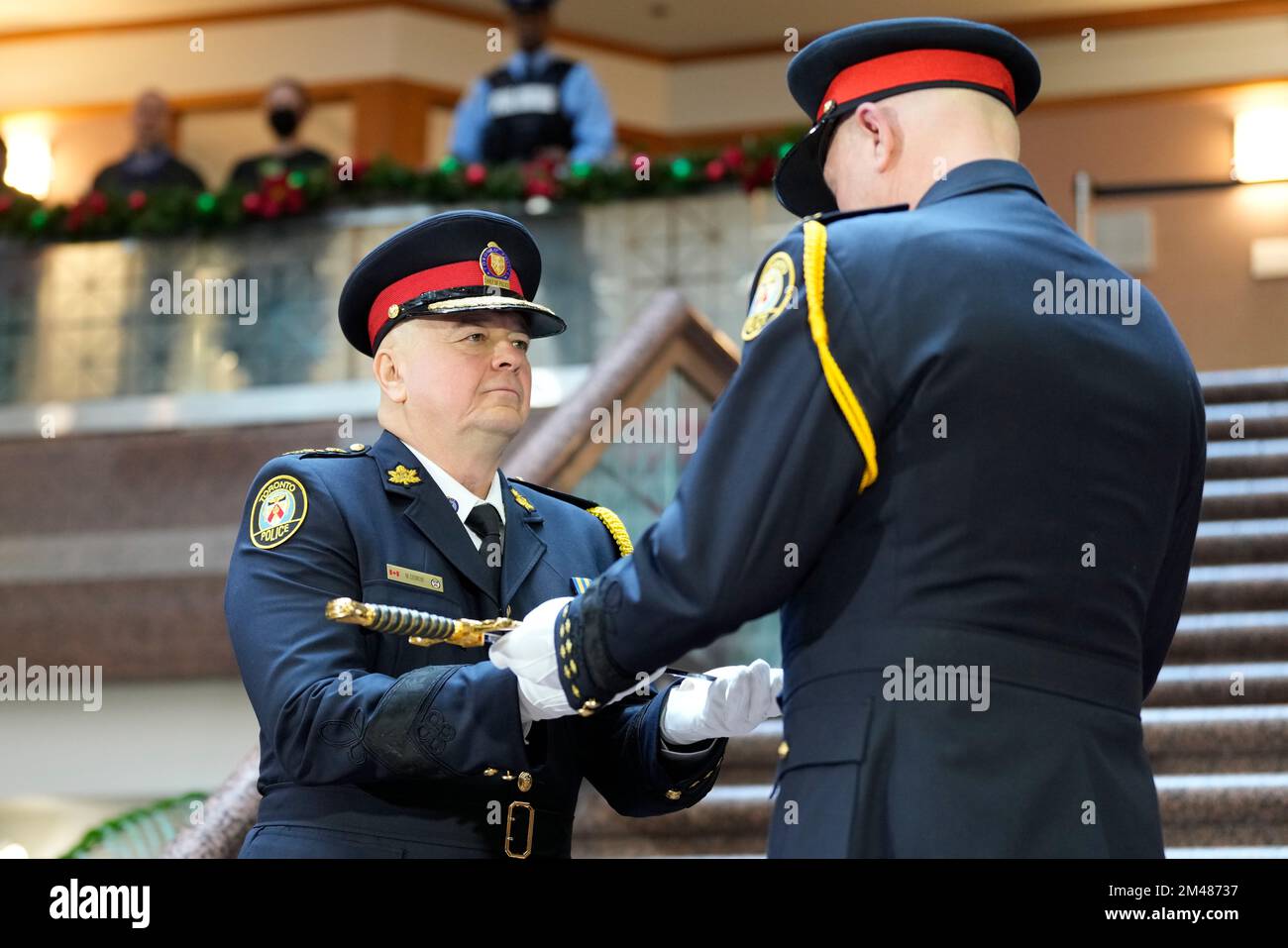Incoming Toronto Police Chief Myron Demkiw (left) is presented with the ...