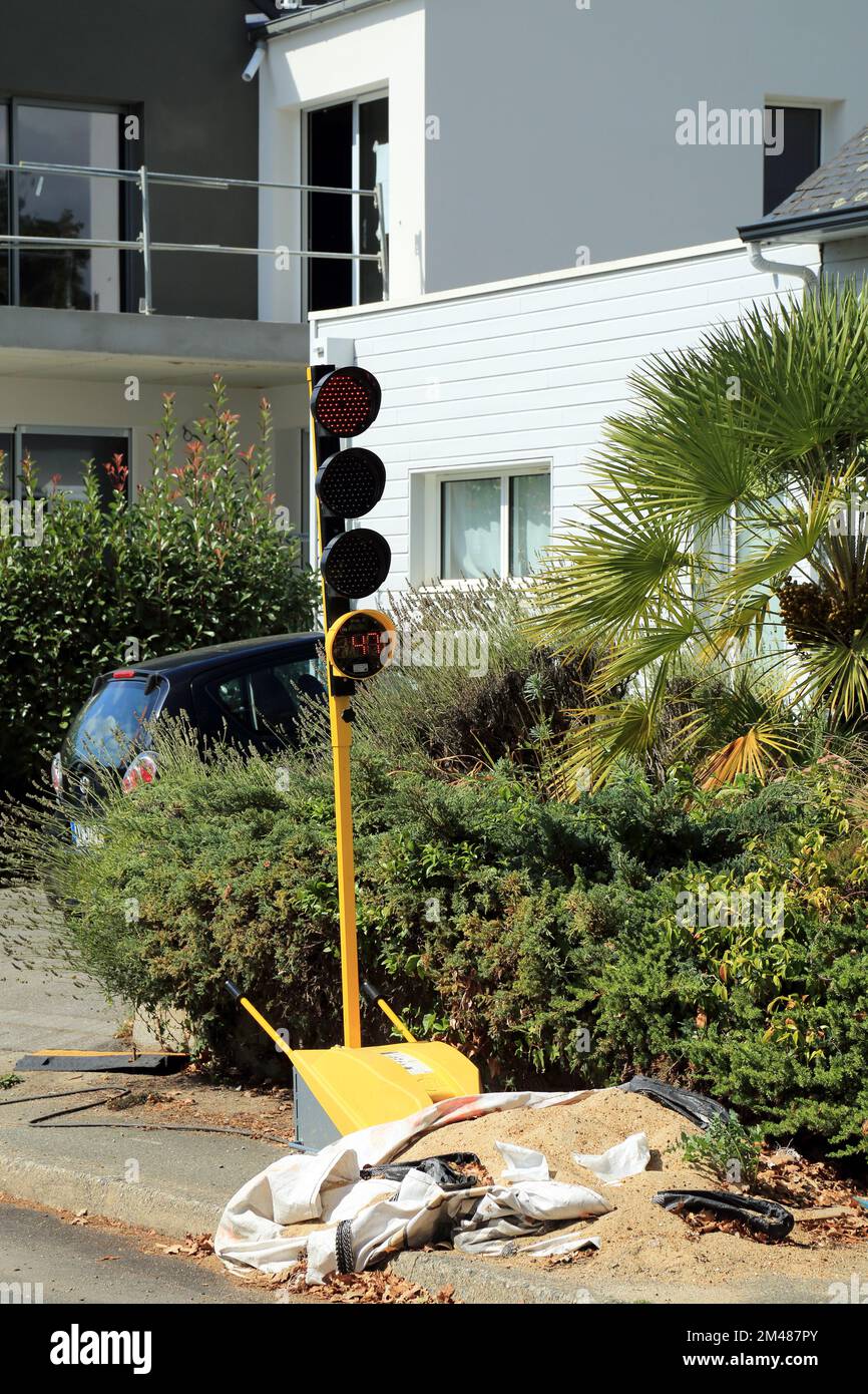temporary traffic light in street with fourth light counting down the ...
