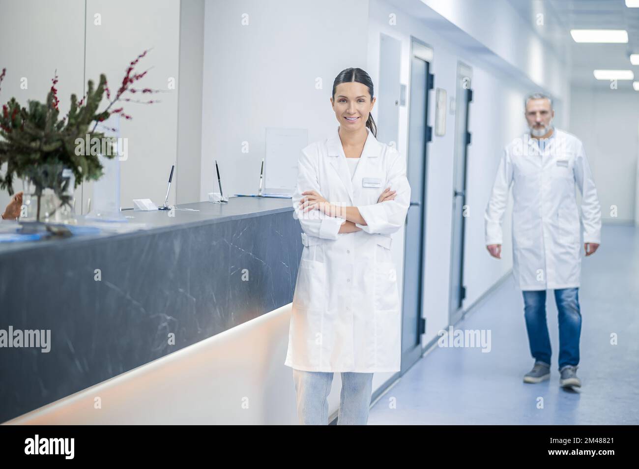 Doctors in lab coats in the clinic corridor Stock Photo - Alamy