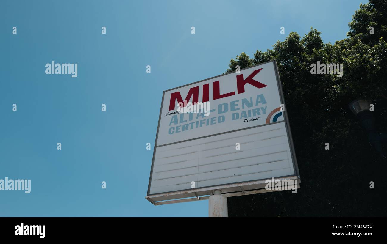 The Old Milk advertising billboard LA under green trees and blue sky ...