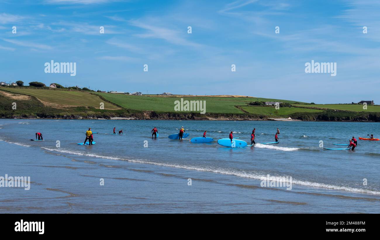 County Cork, Ireland, August 6, 2022. Young people are surfing. A surf ...
