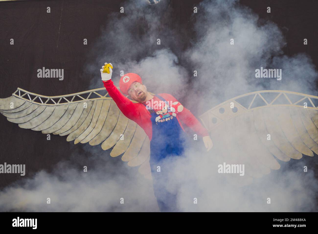 A male cosplaying as Super Mario surrounded by smoke at the Comic-Con ...