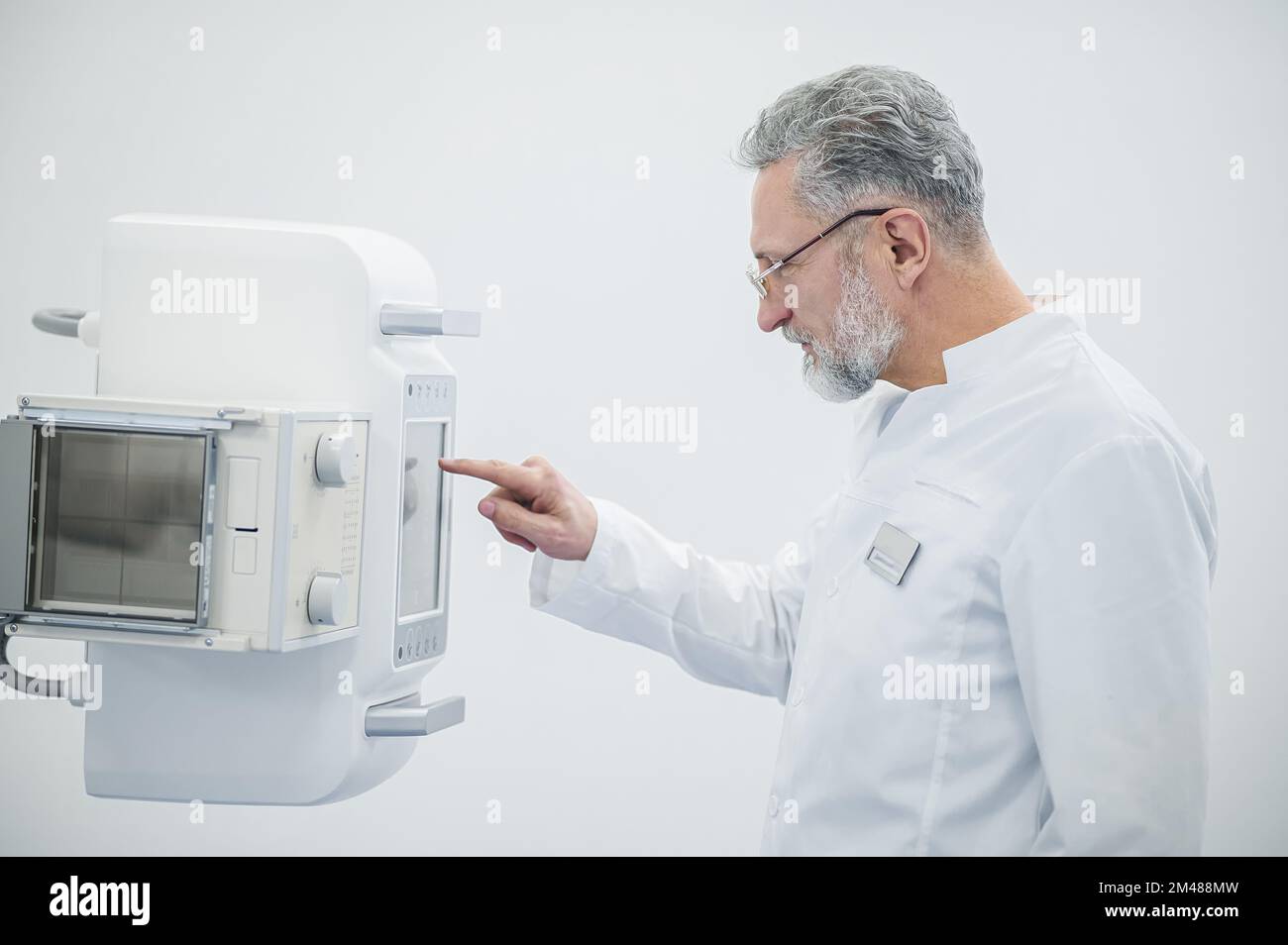 Male doctor getting the equipment ready for mammography Stock Photo - Alamy