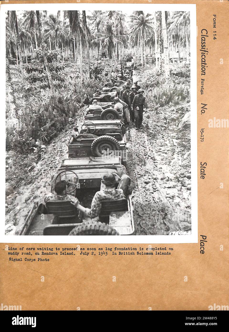 Muddy Road on Rendova Island. Original caption: Line of cars waiting to ...