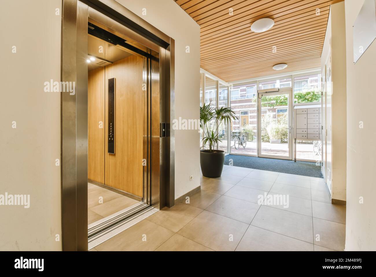 an entry way with wooden ceilinging and glass doors leading to the ...