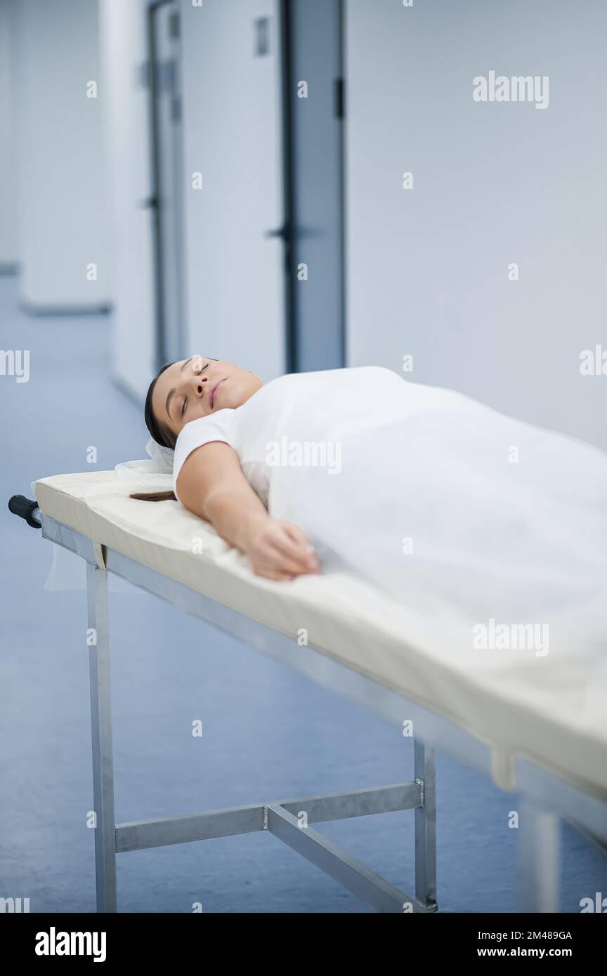 A woman lying on a gurney befre diagnostic procedure Stock Photo - Alamy