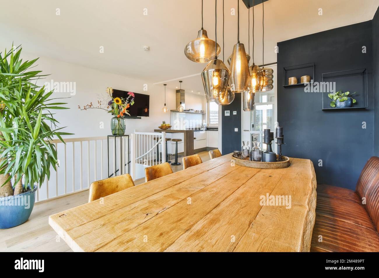 a dining room with a wooden table and some plants in pots on the wall ...