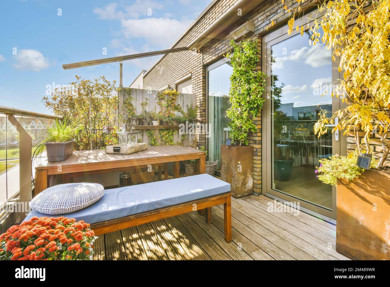 a balcony with flowers and plants on the decking area, as seen from the ...