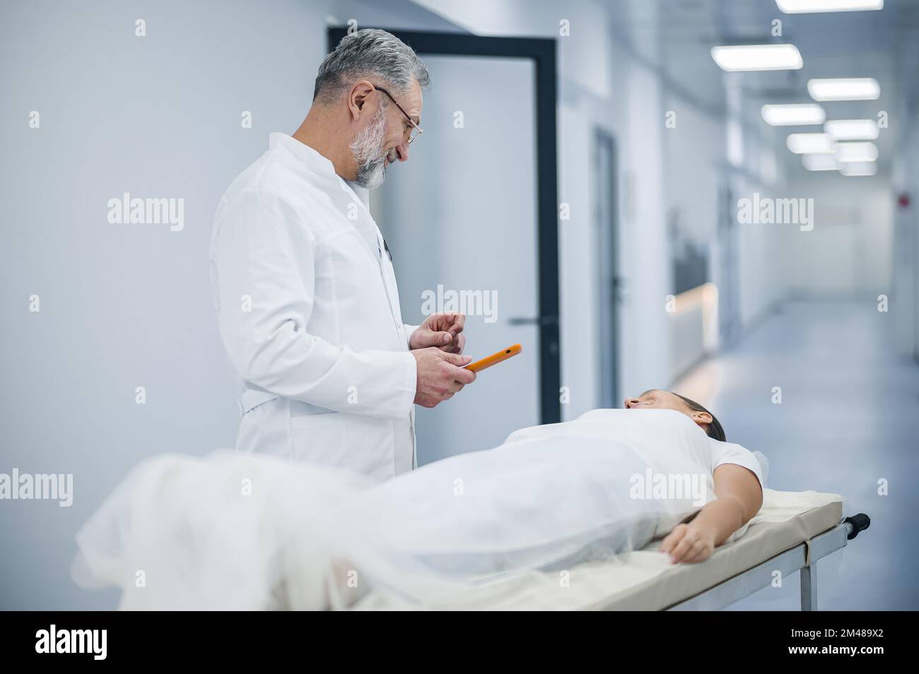 A doctor talking with a patient before MRI procedure Stock Photo - Alamy