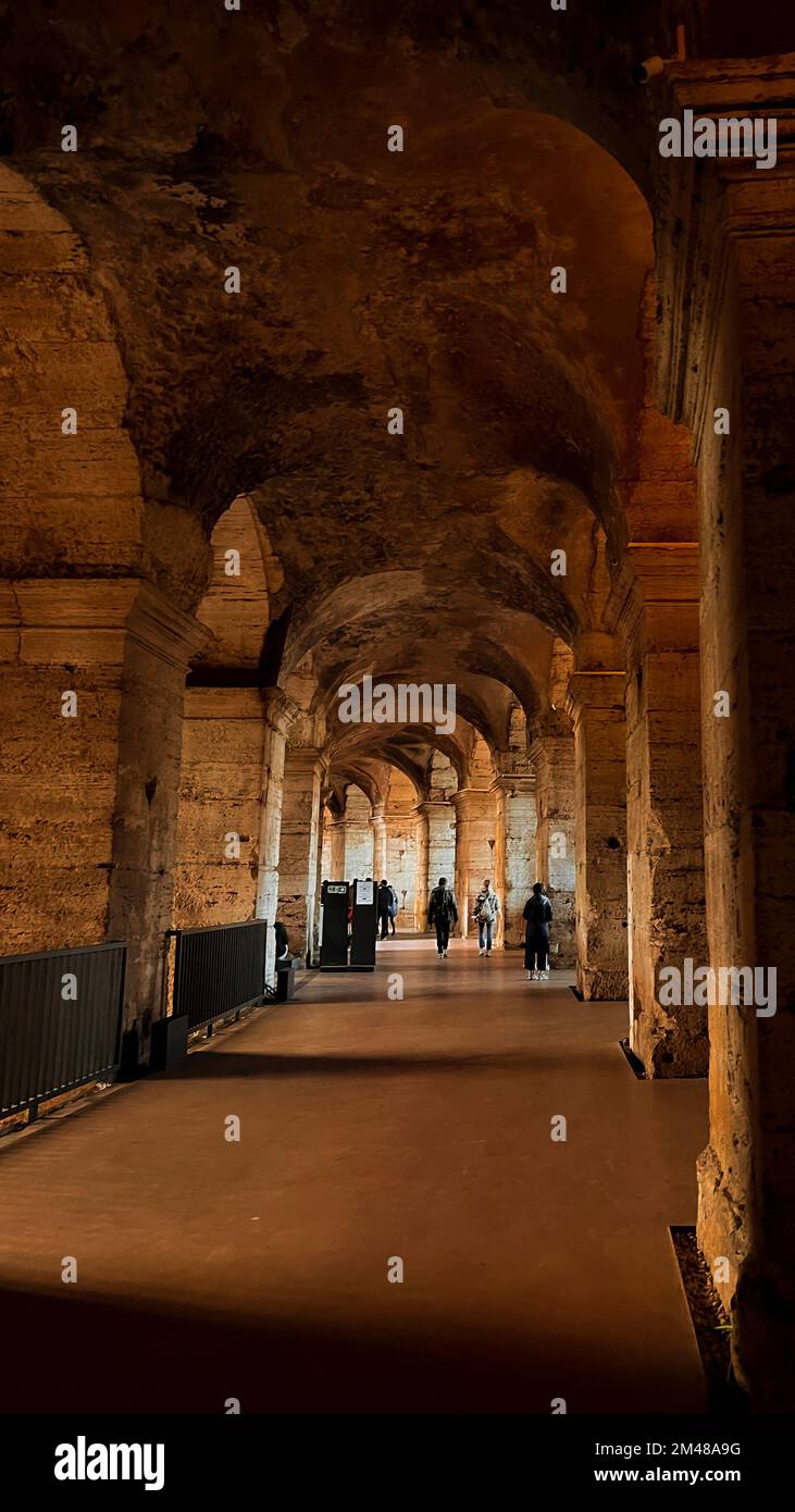 A vertical shot of a corridor inside an ancient building with arches ...