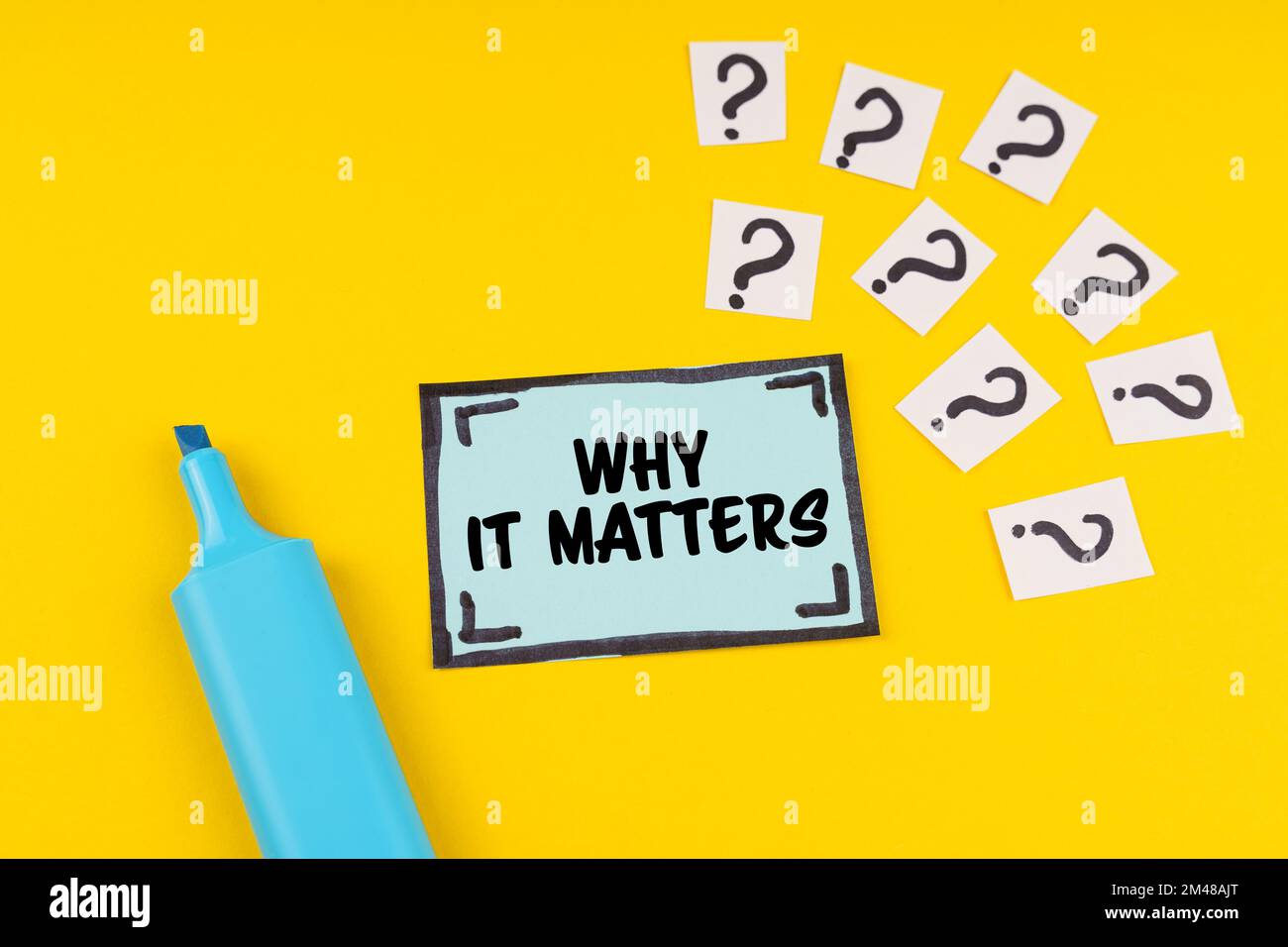 Business concept. On the yellow surface lies a blue marker, question ...