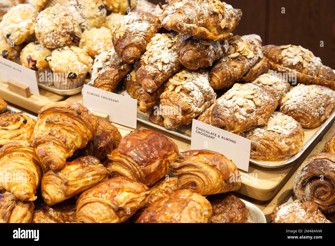 A mix of baked goods beautifully arranged on a shelf including ...