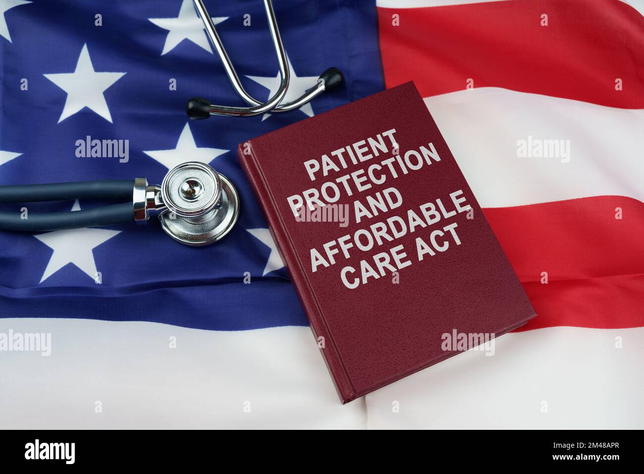 Law concept. On the US flag lies a stethoscope and a book with the ...