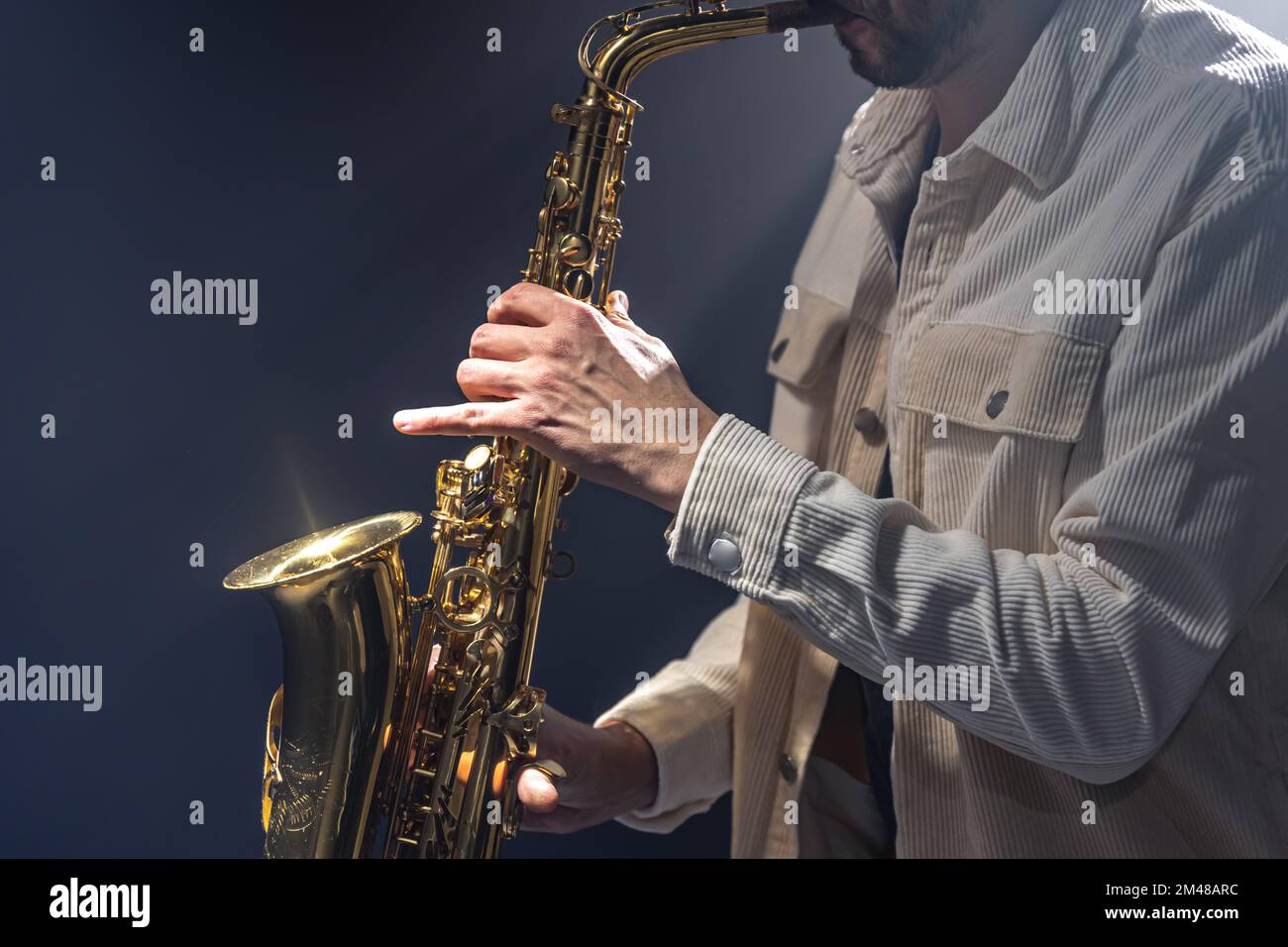 Male musician on stage plays the saxophone dark with smoke Stock Photo ...
