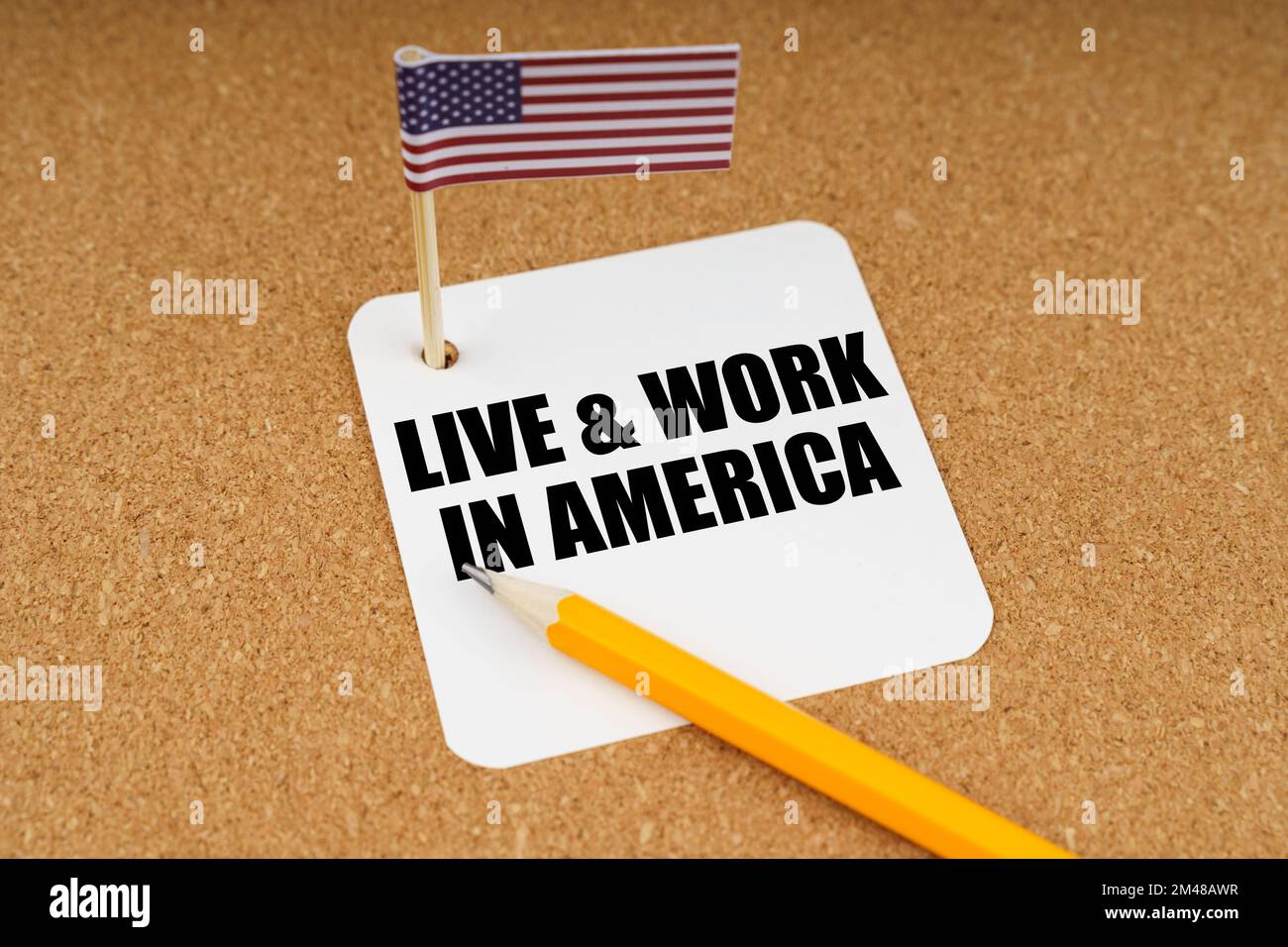 On the table is the US flag, a pencil and a sheet of paper from a ...