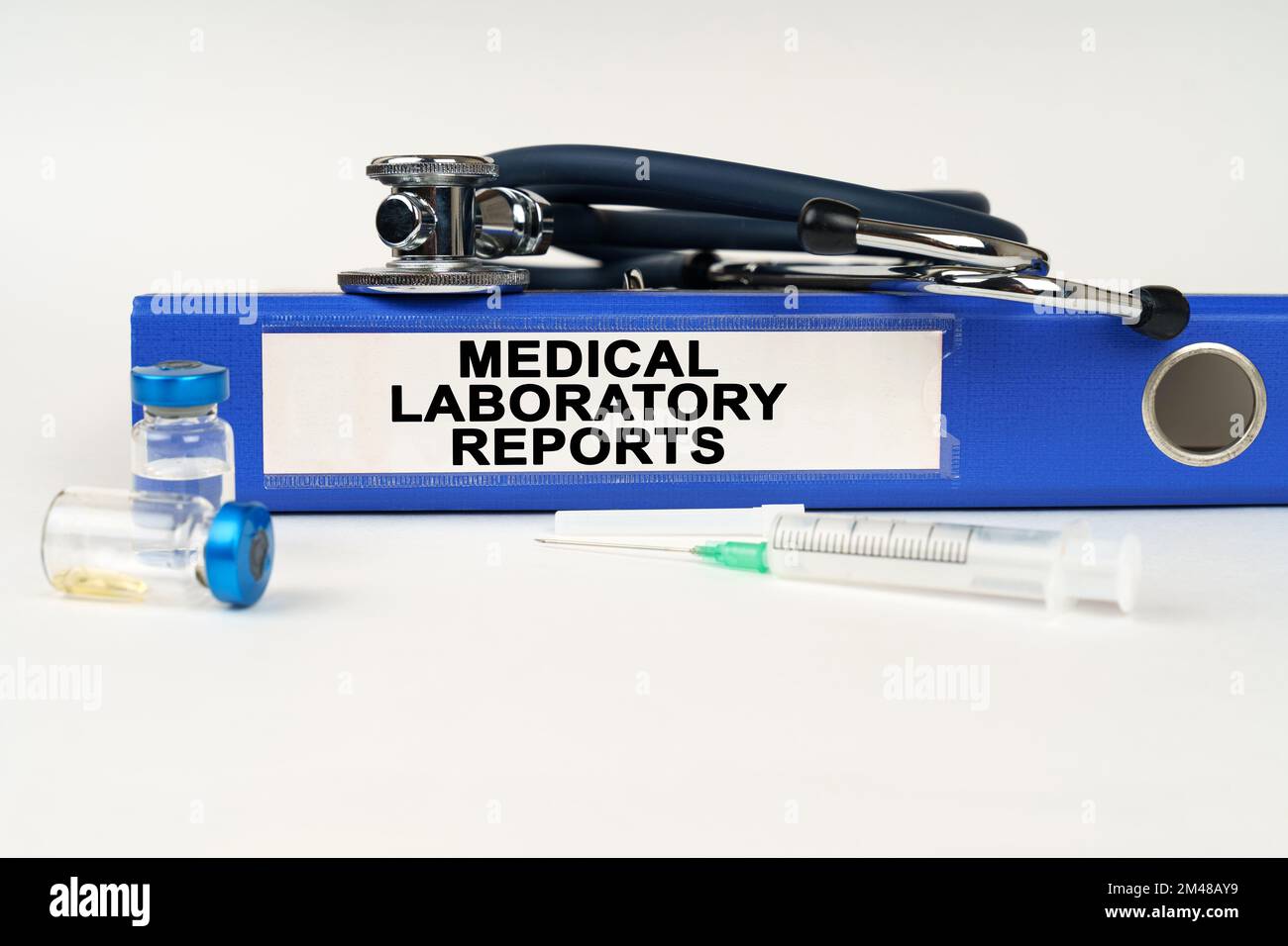 Medical concept. On a white surface, a syringe, a stethoscope and a ...