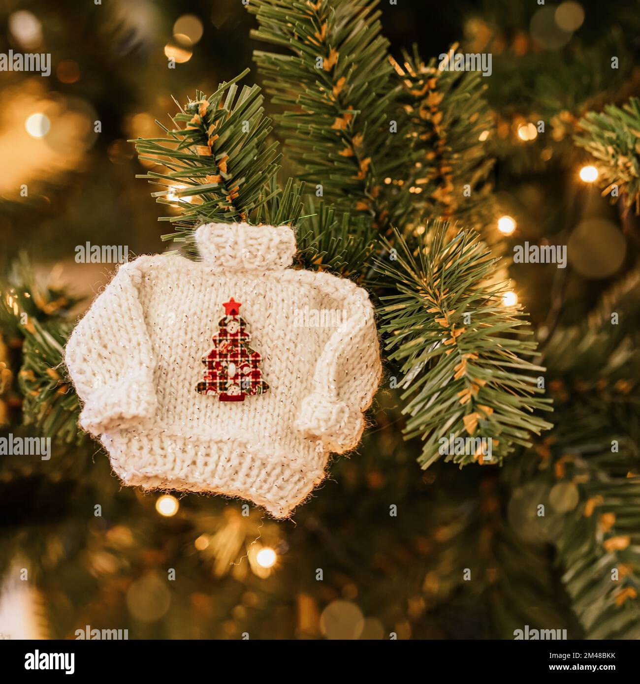 Christmas tree decoration in form of knitted sweater. Happy New Year ...