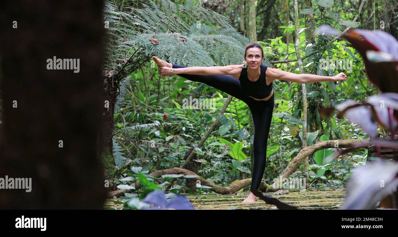 Yogi woman training Yoga asana balance pose outdoor in nature Stock ...