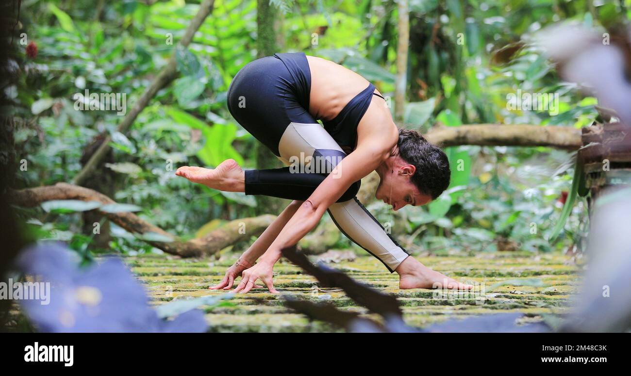 Yogi woman training strength asana pose outside in nature Stock Photo ...