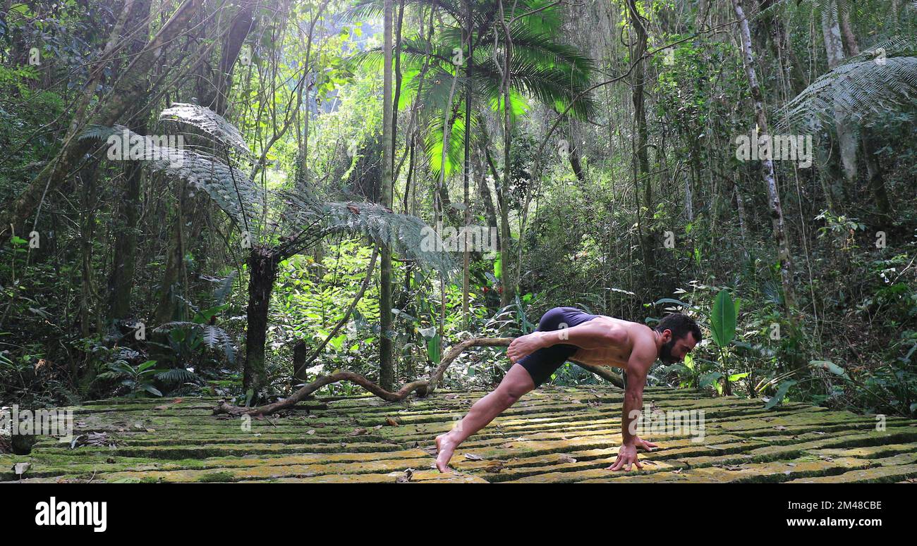 Yogi man training Yoga in the middle of tropical jungle Stock Photo - Alamy