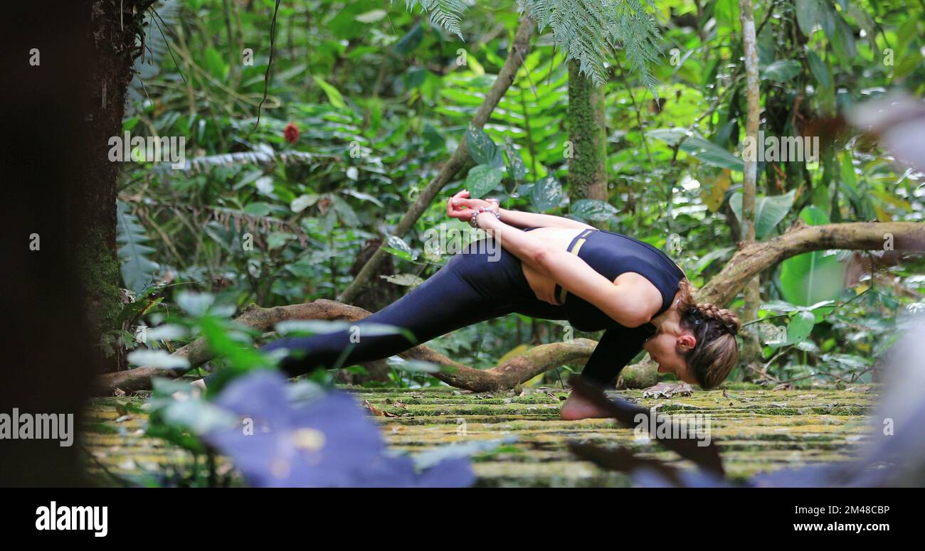 Yogi woman training asana pose outdoors in nature Stock Photo - Alamy