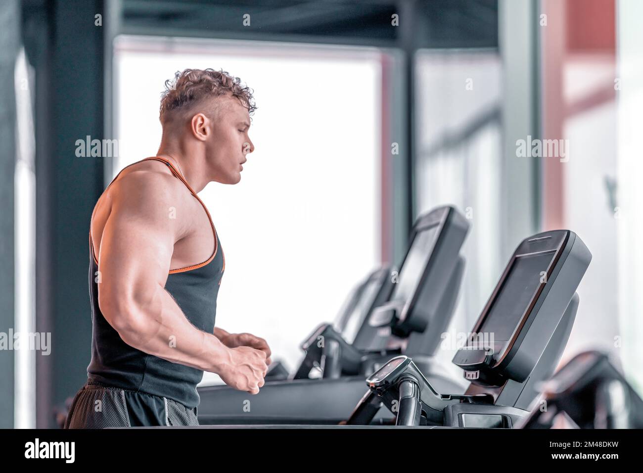 young athlete runs on a treadmill in the gym Stock Photo - Alamy
