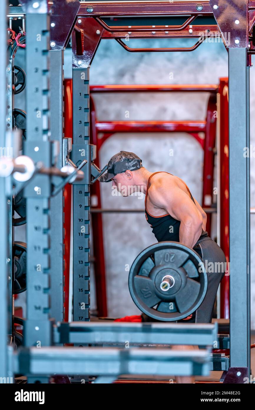 young athlete lifts barbell in gym Stock Photo - Alamy