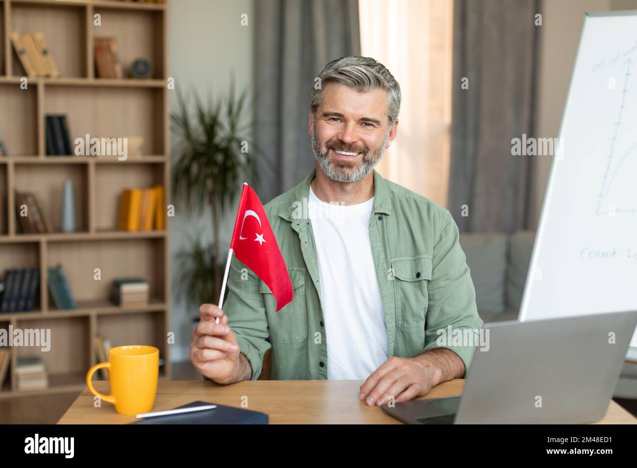 Glad smiling elderly caucasian man teacher tutor with Turkey flag ... Glad smiling elderly caucasian man teacher tutor with Turkey flag ...