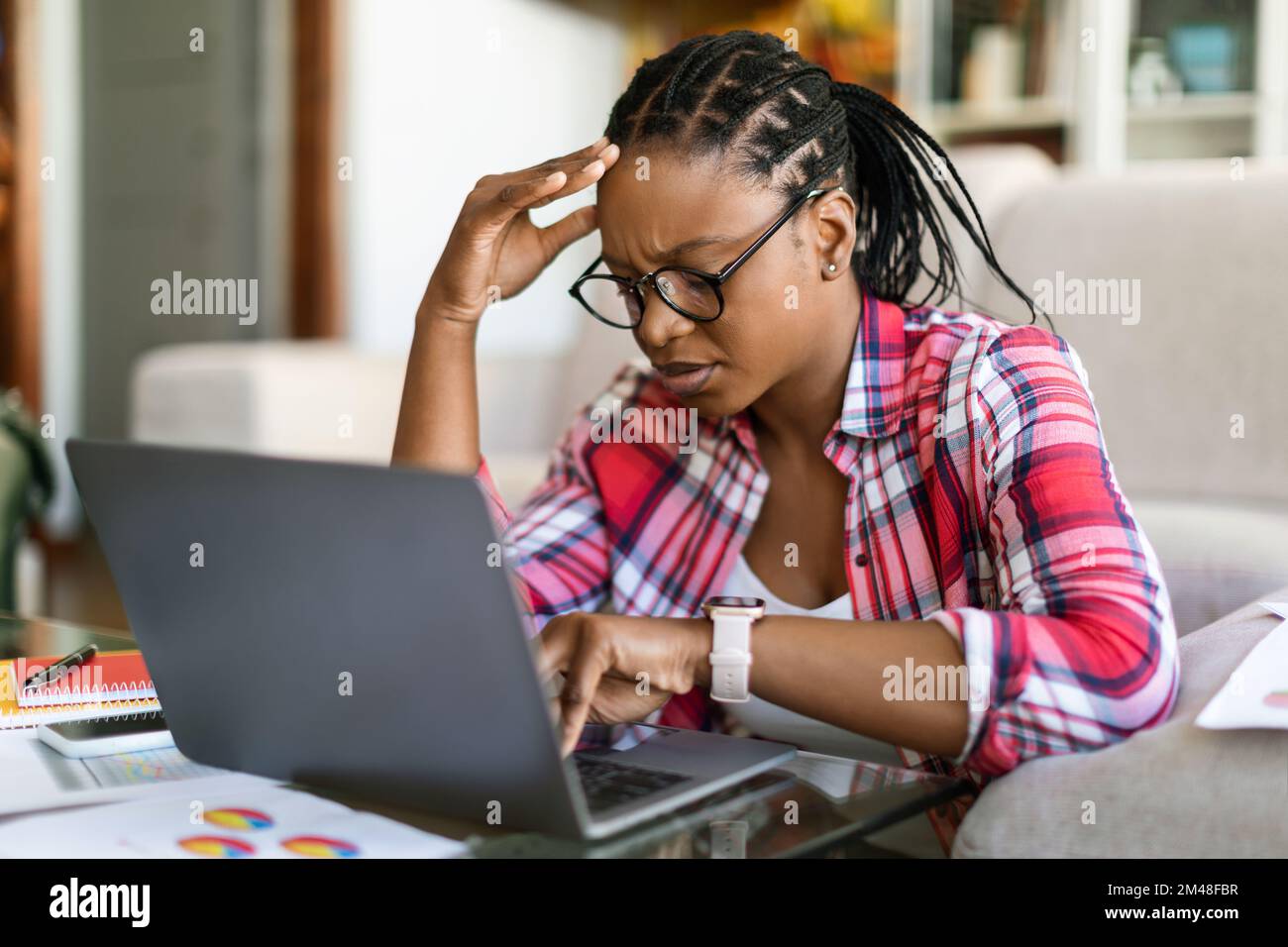 Depressed upset african female sit at workplace, using computer Stock ...