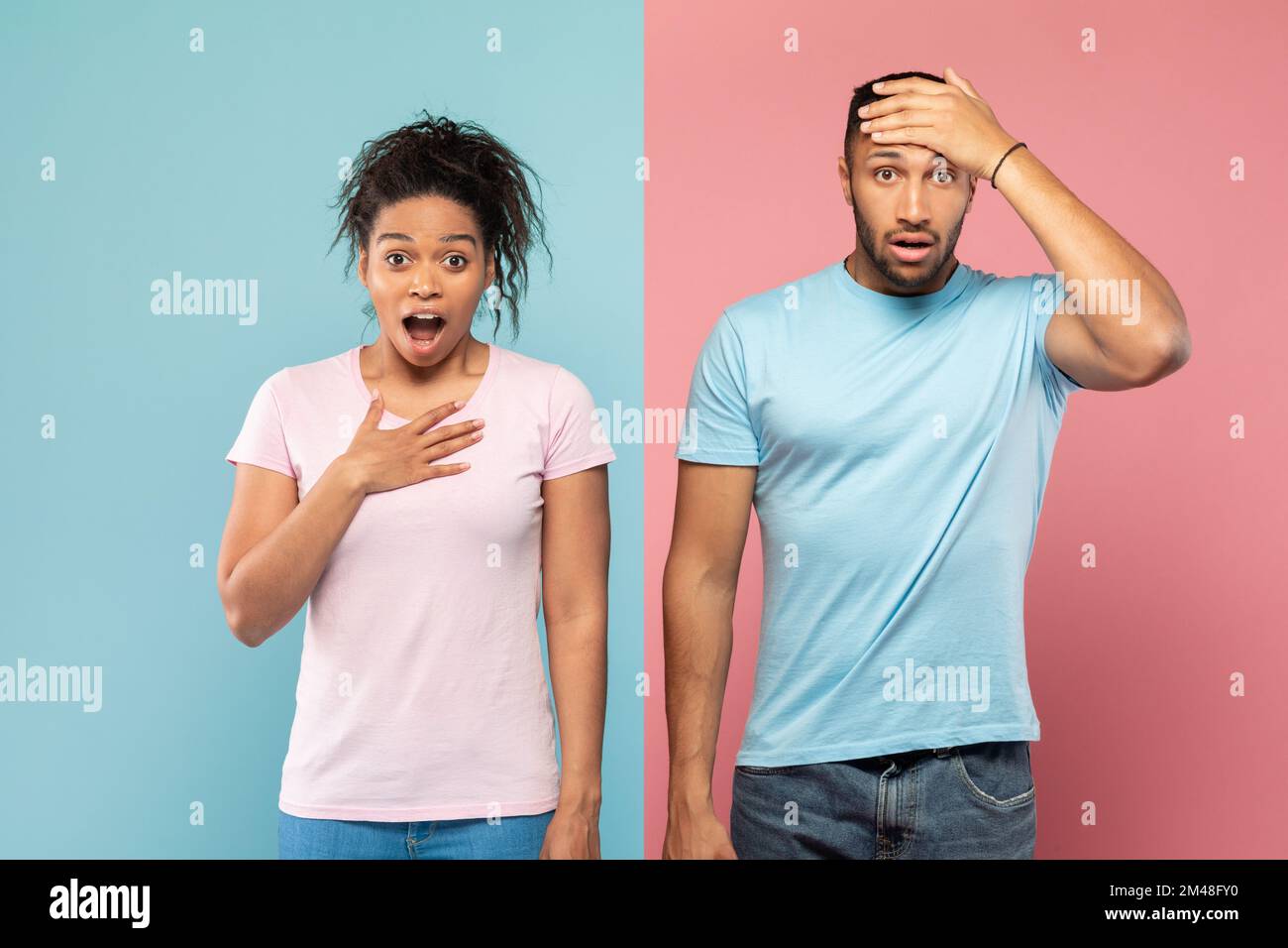 Shocked black couple opening mouths in shock, woman putting hand on ...