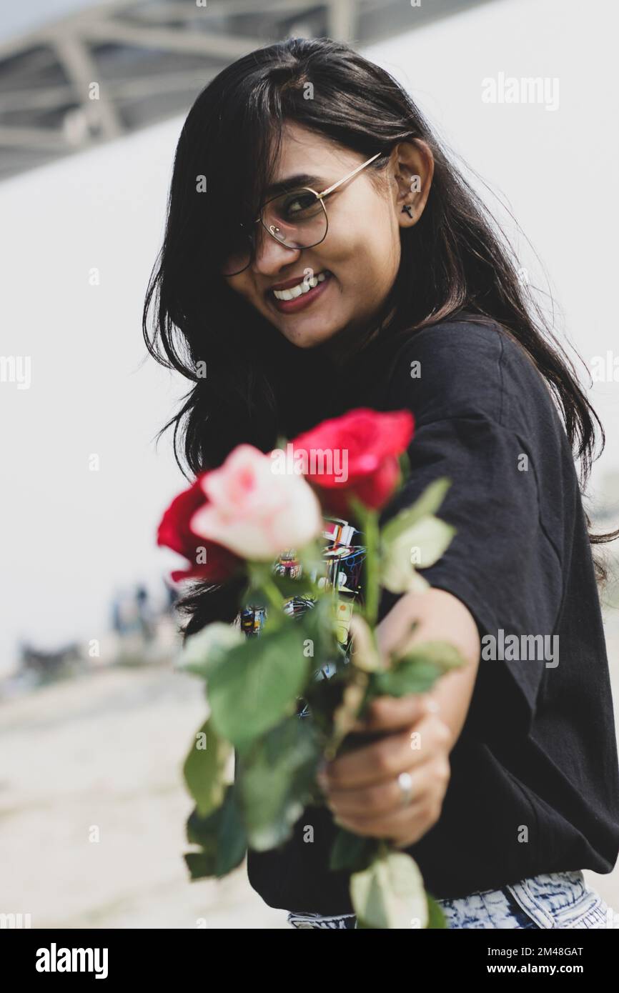 beautiful girl holding red roses Stock Photo - Alamy