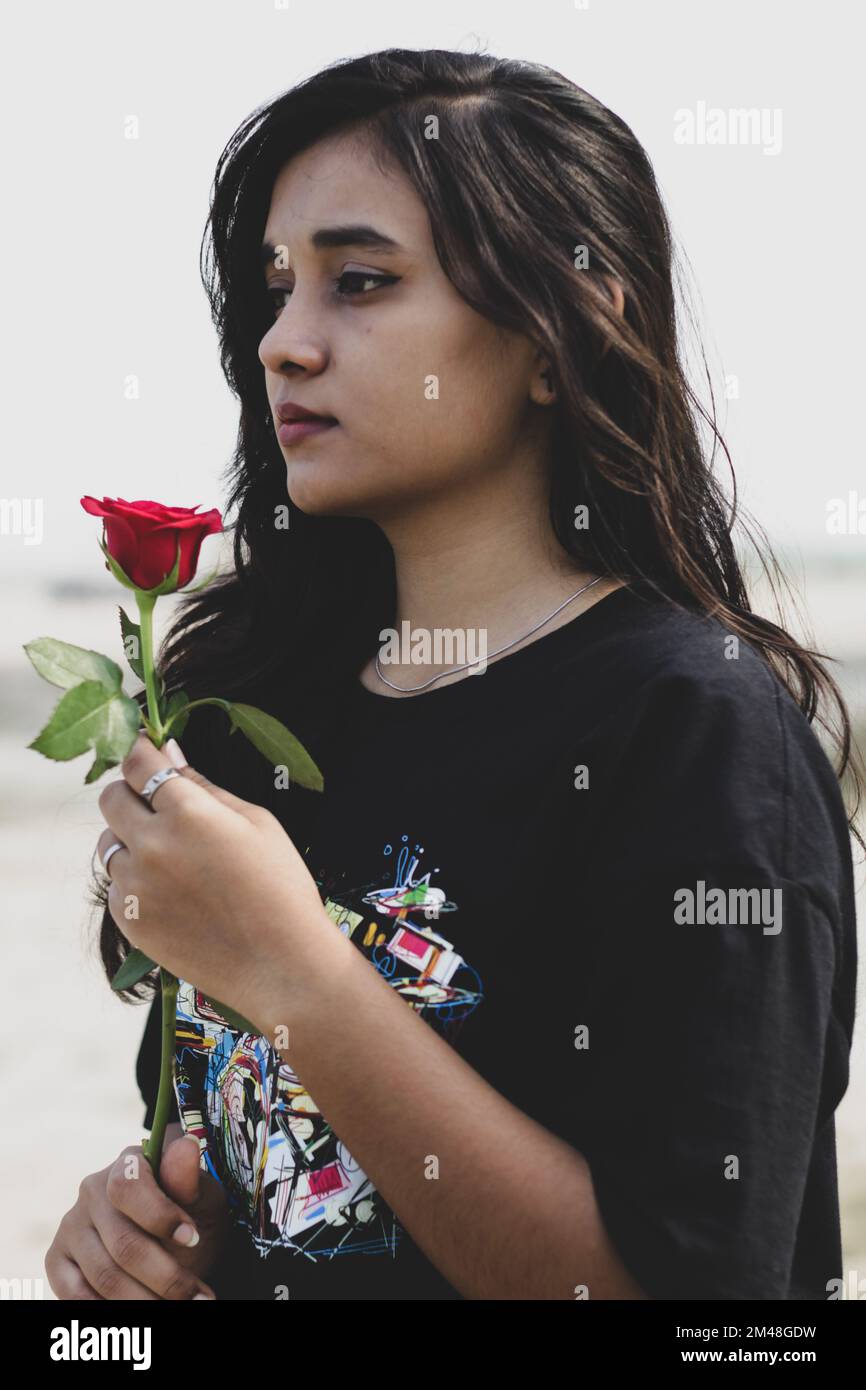 beautiful girl holding red roses Stock Photo - Alamy