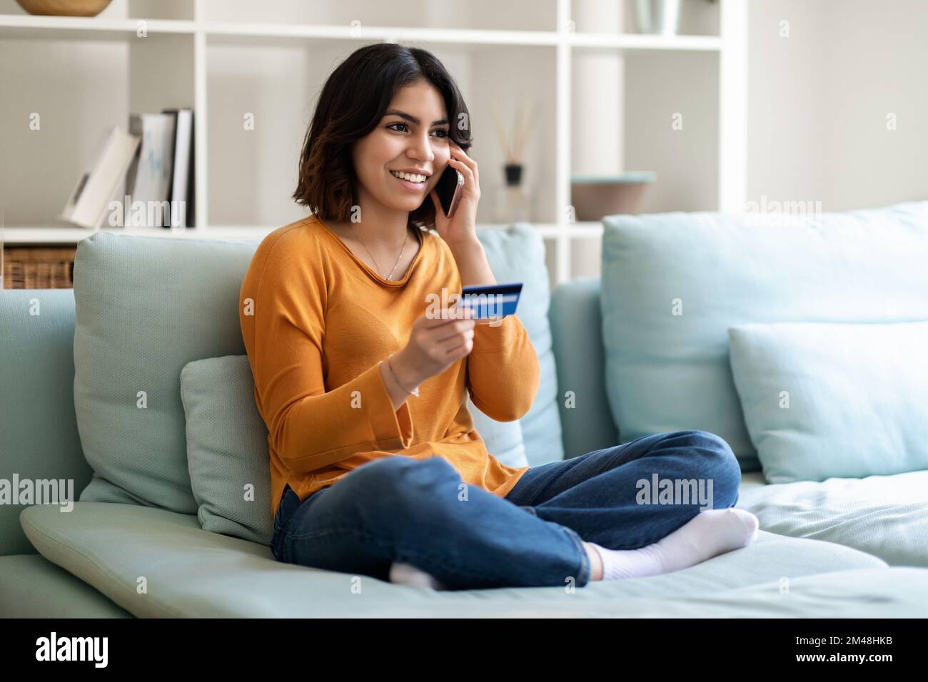 E-commerce Concept. Happy Arab Woman Holding Credit Card And Talking On ...