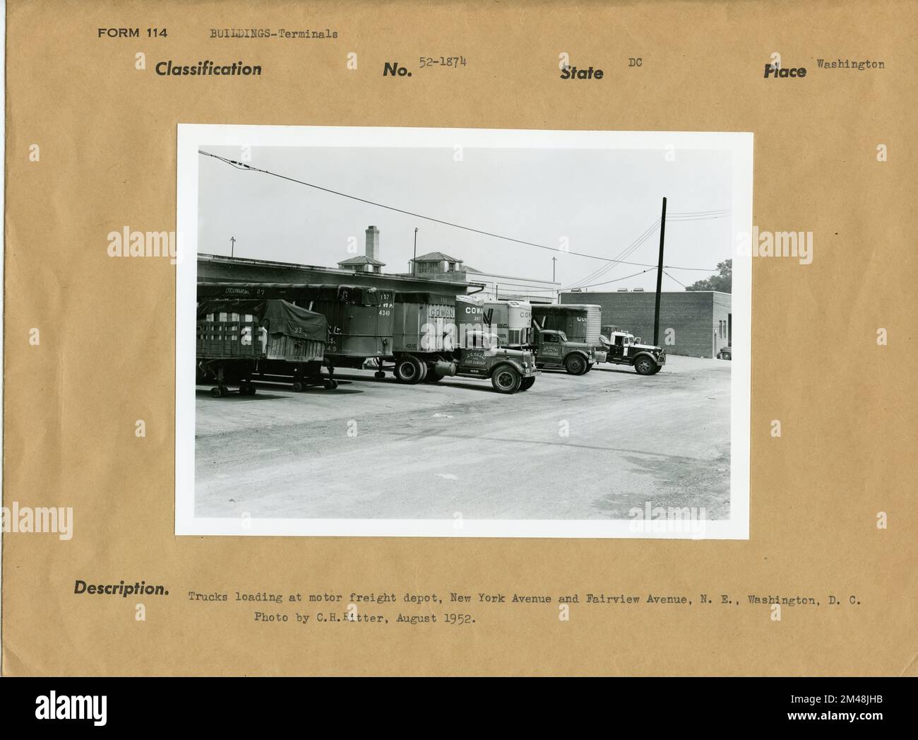 Trucks Loading at Motor Freight Depot. Original caption: Trucks loading ...