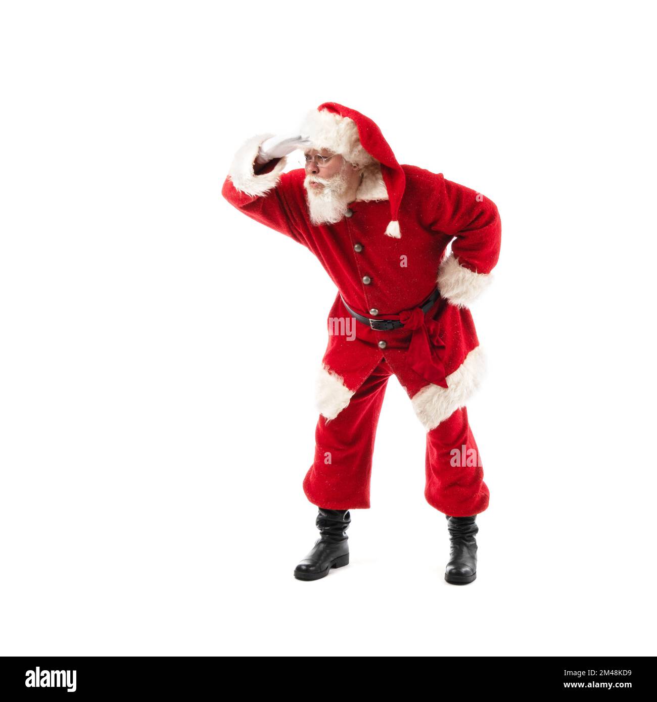 Santa Claus standing isolated on white background and peering far away ...