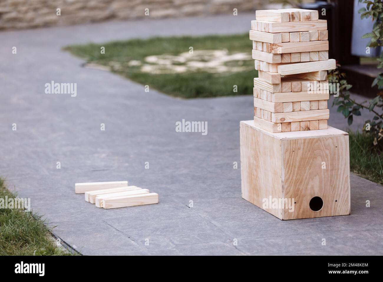 Jenga, multistory tower of wooden blocks. Group game of physical skill ...