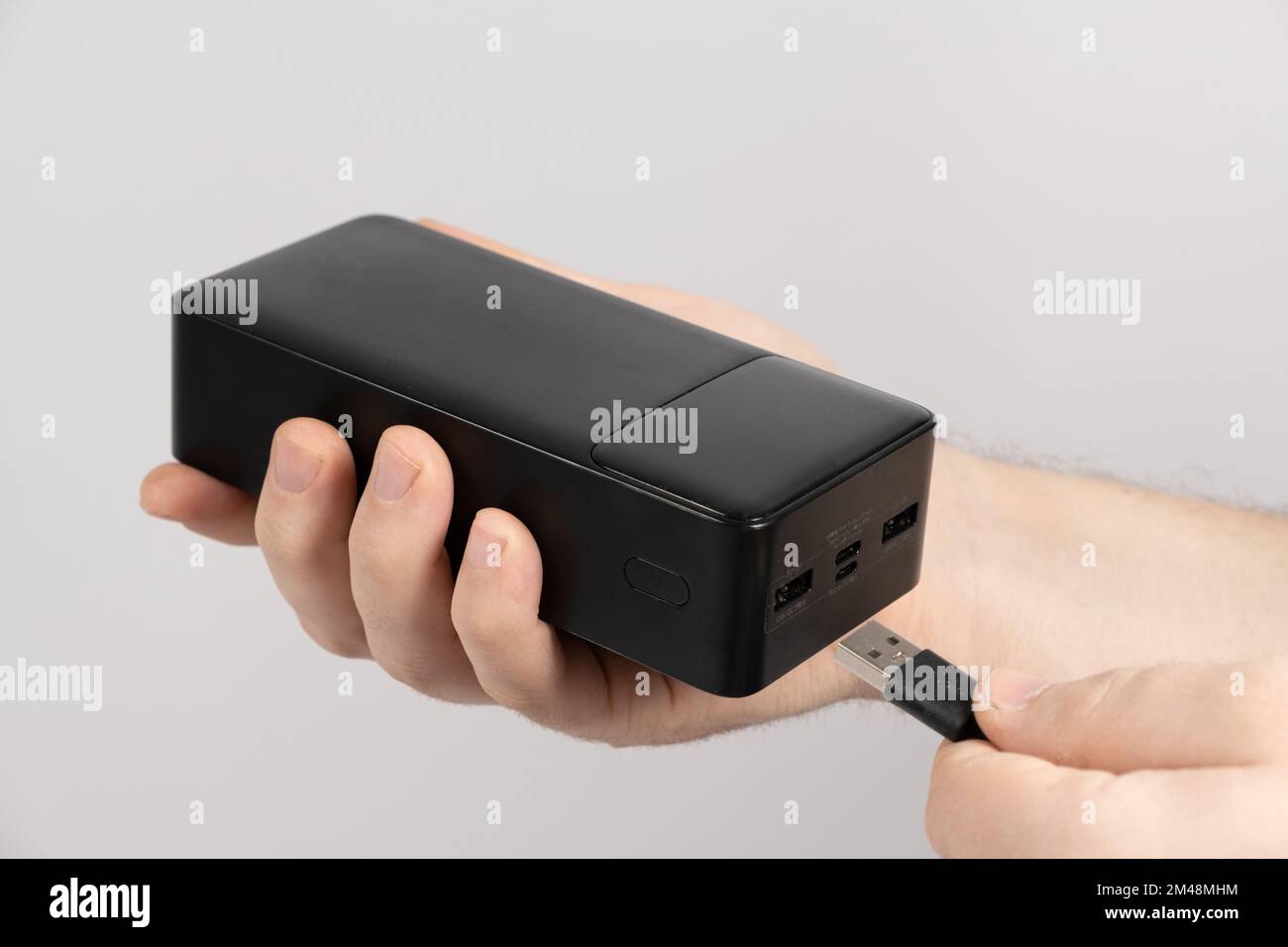 Connecting the cord to the power bank. Charging gadgets from the power ...