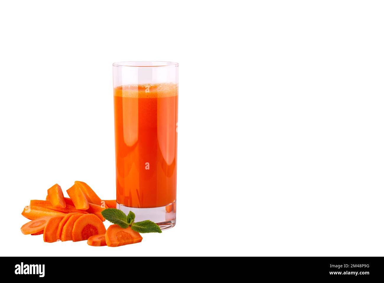 Glass of carrot juice with a some pieces of carrot on a white isolated ...