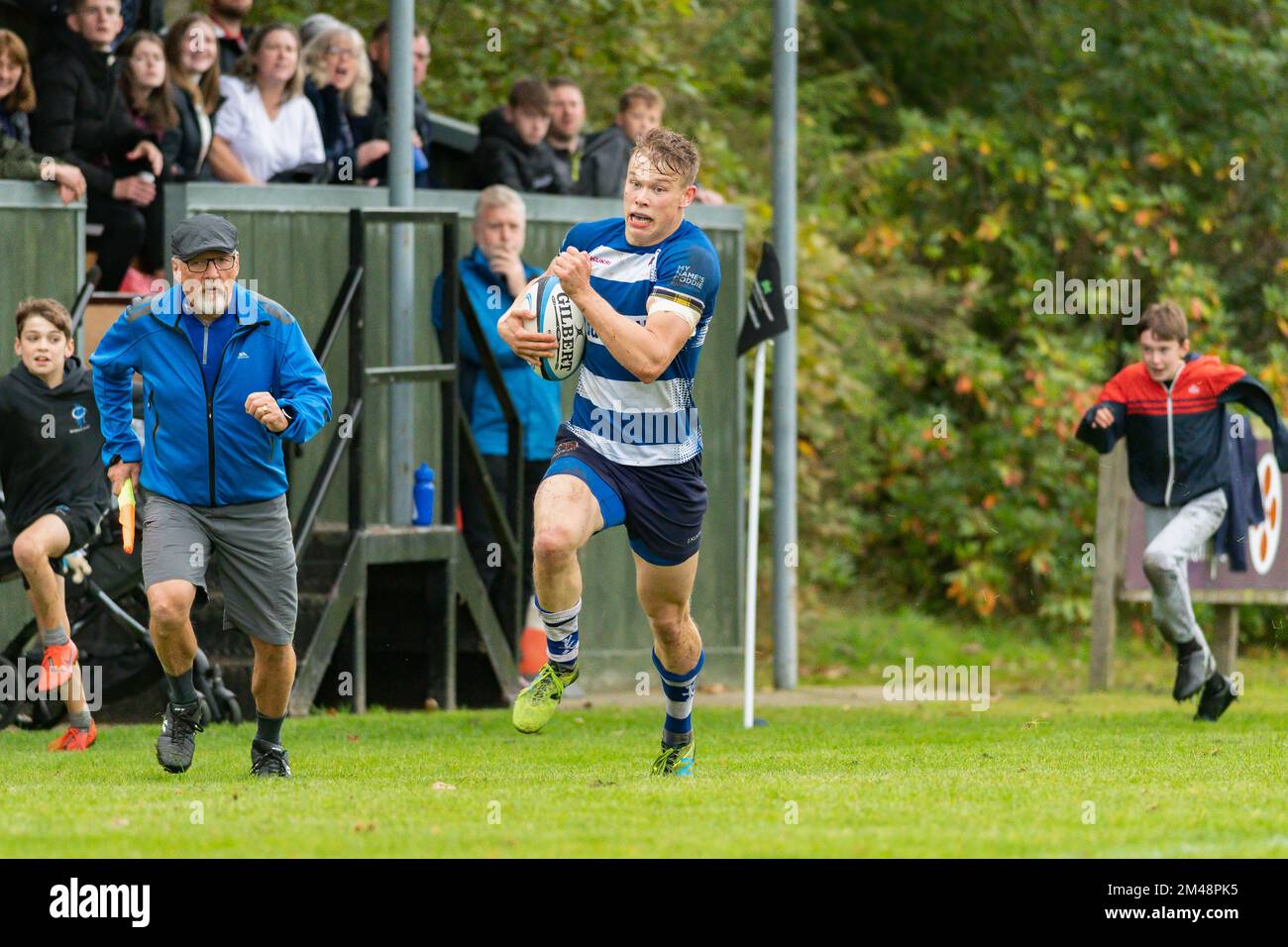 Howe of Fife player sprints down the side line with supporters looking ...