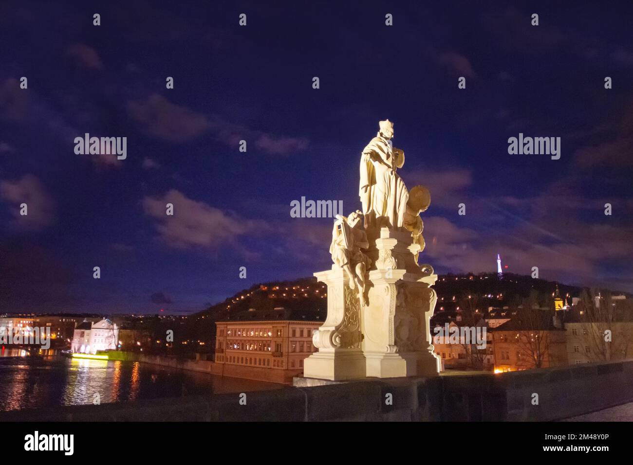 Old medieval Statue on Charles bridge in Prague - night in winter - illuminated - pedestrian ...