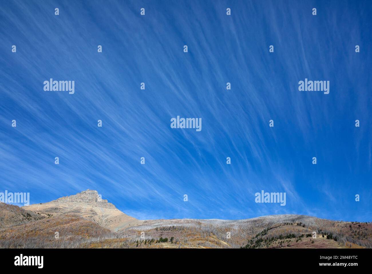 Cirrus clouds in blue sky over the Rocky Mountains in Wateron Lakes ...