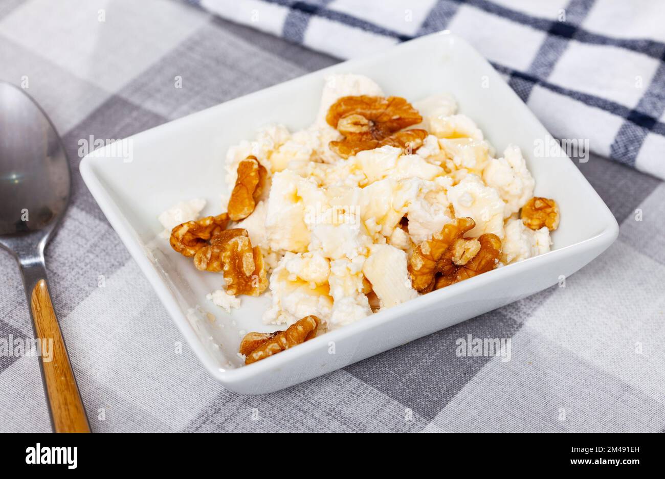 Portion of traditional Catalan dessert, mato with honey and nuts Stock ...