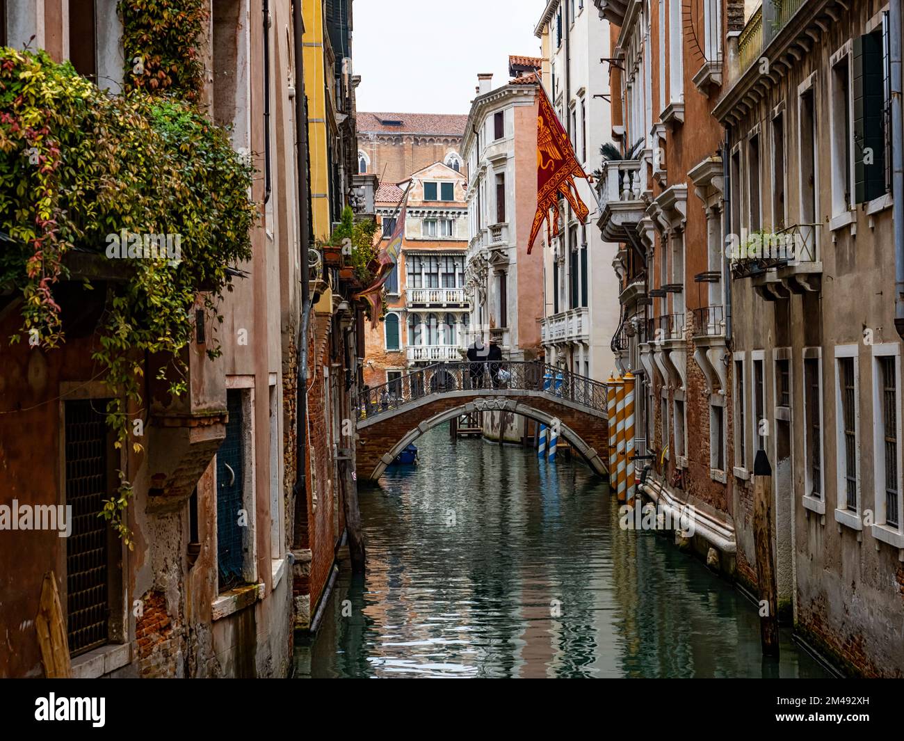 Typical canal of Venice with San Marco flag Stock Photo - Alamy