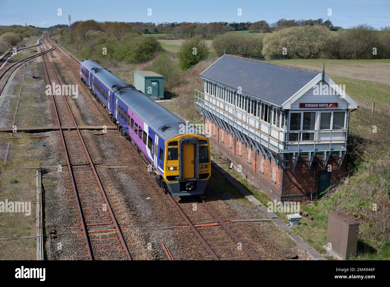 Northern Rail class 158 diesel train 158754 passing the mechanical signal box at Kirkham North ...