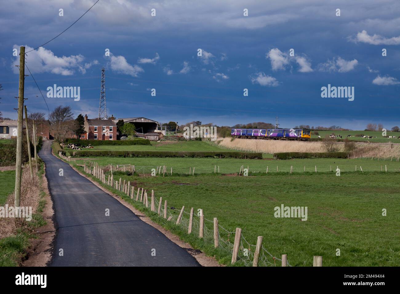 Northern Rail class 142 pacer train 142012 and class 150 sprinter 150211 passing the open rural ...
