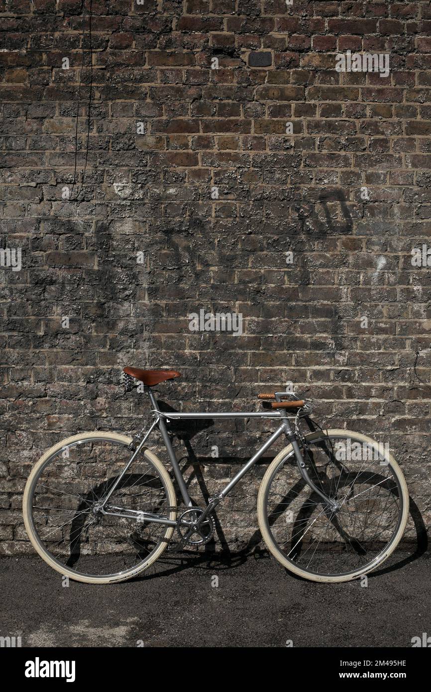 Old brick wall with bespoke bicycle Stock Photo - Alamy